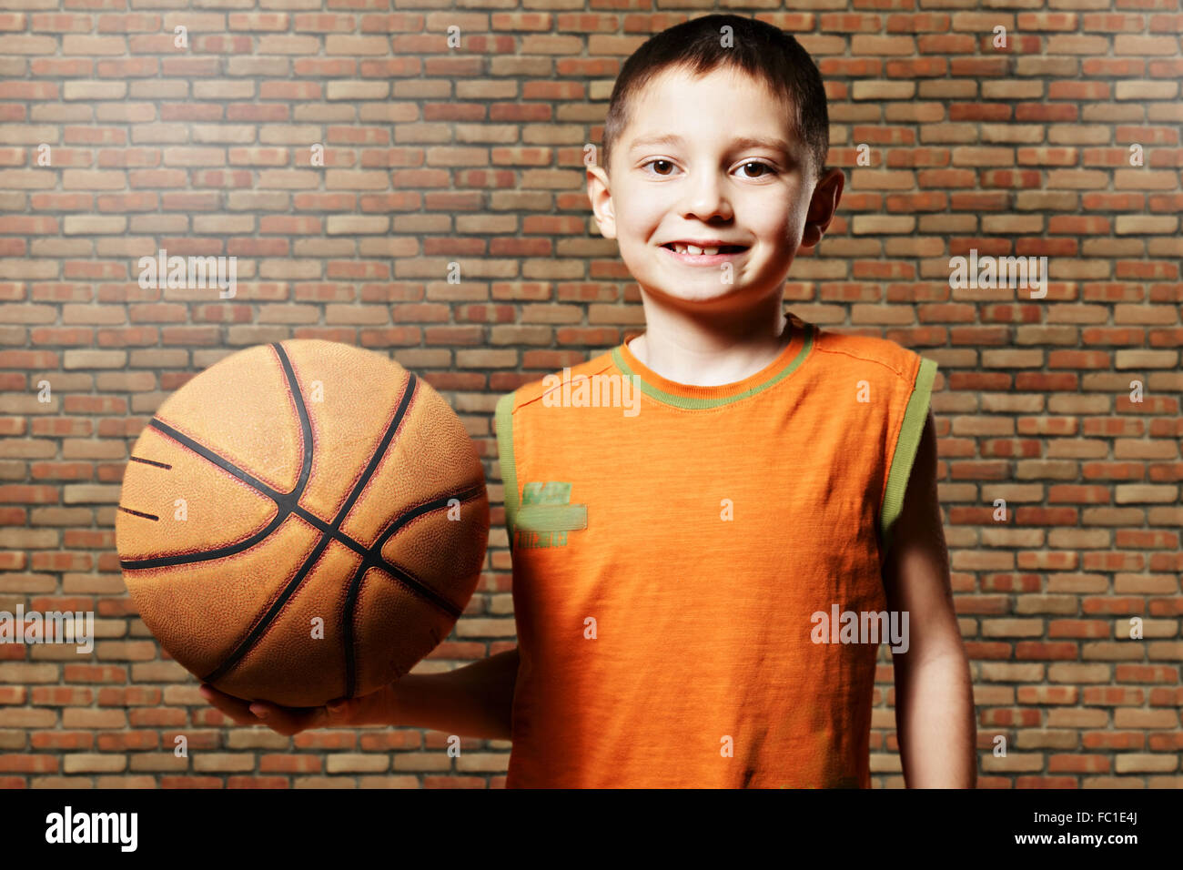 Smiling kid with basketball Stock Photo - Alamy