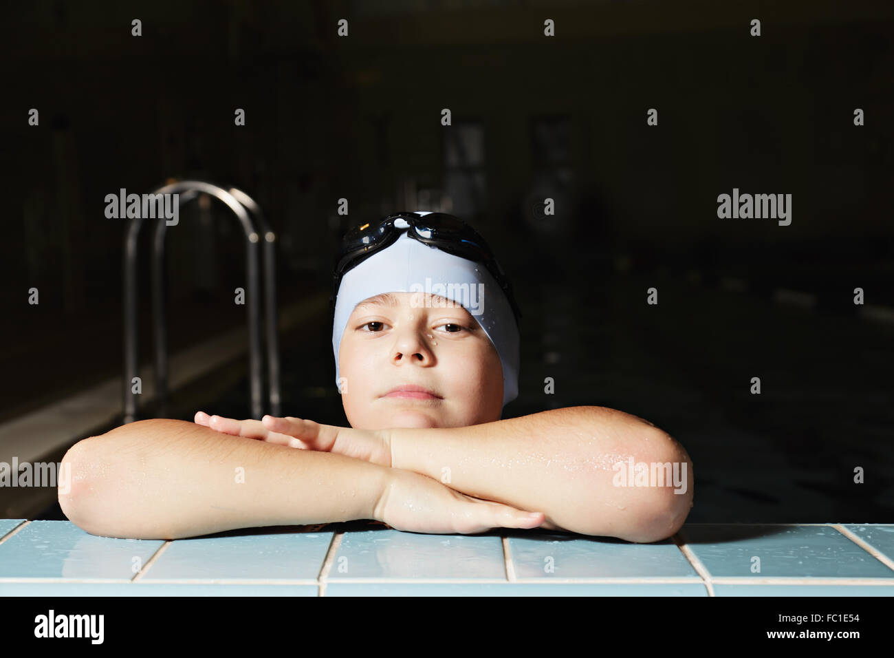 Contented kid at the swimming pool side Stock Photo - Alamy