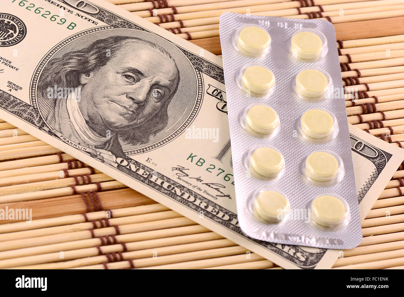 Pills and american money close-up background Stock Photo - Alamy