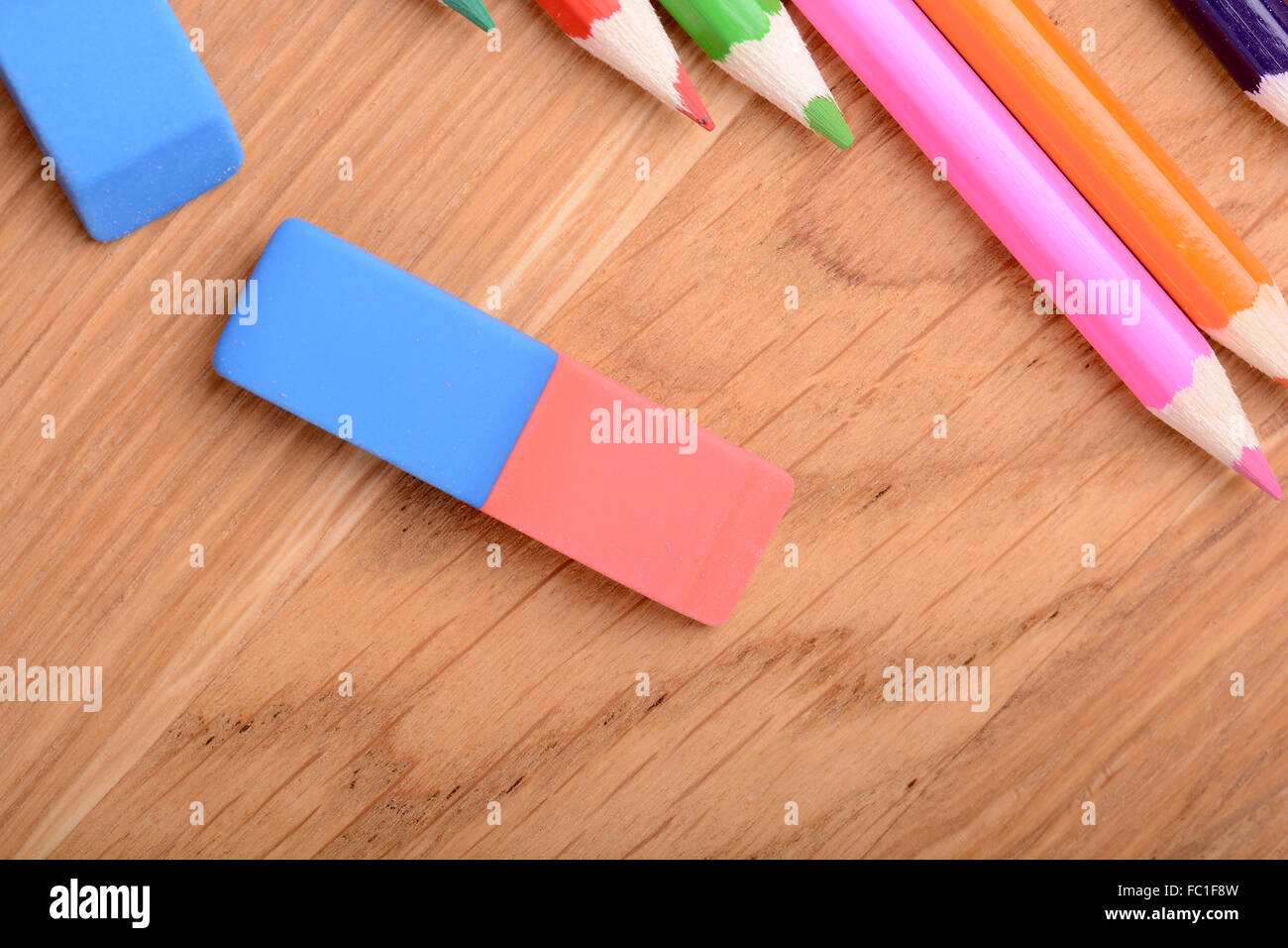 colored pencils on wooden background Stock Photo - Alamy