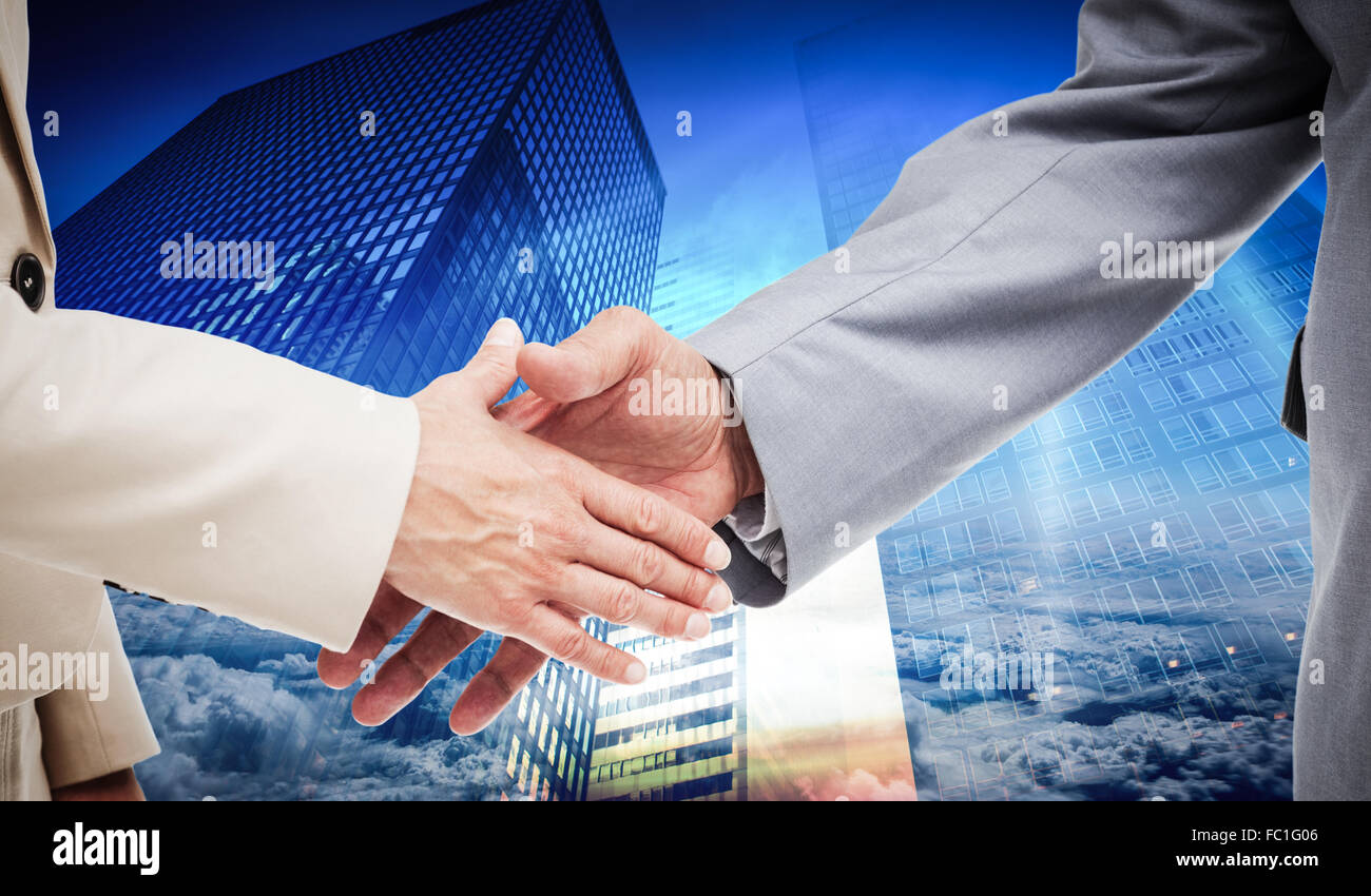 Composite image of close up of business people shaking their hands ...