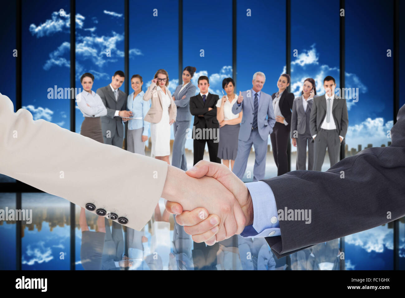 Composite image of smiling business people shaking hands while looking ...