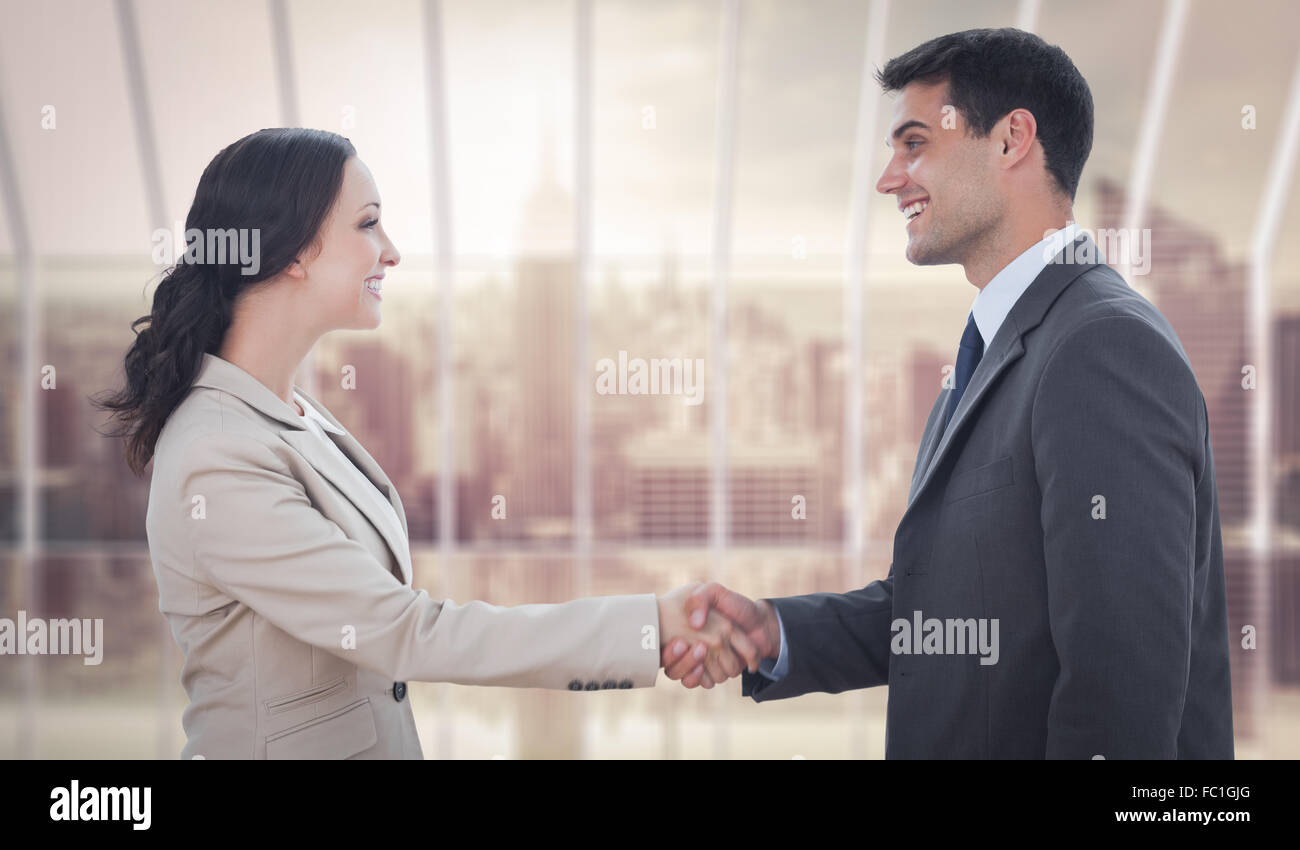 Composite image of future partners shaking hands Stock Photo - Alamy