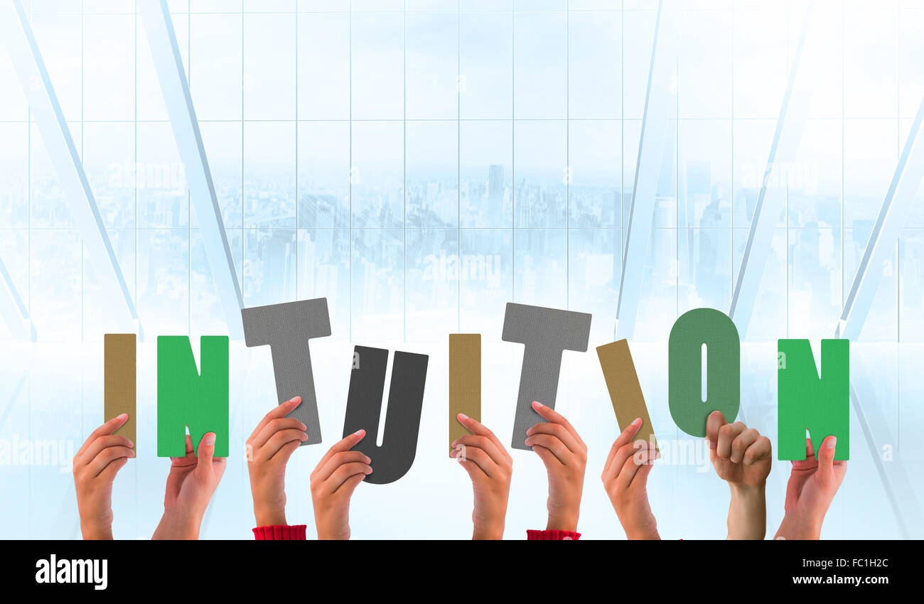 Composite image of hands holding up intuition Stock Photo - Alamy