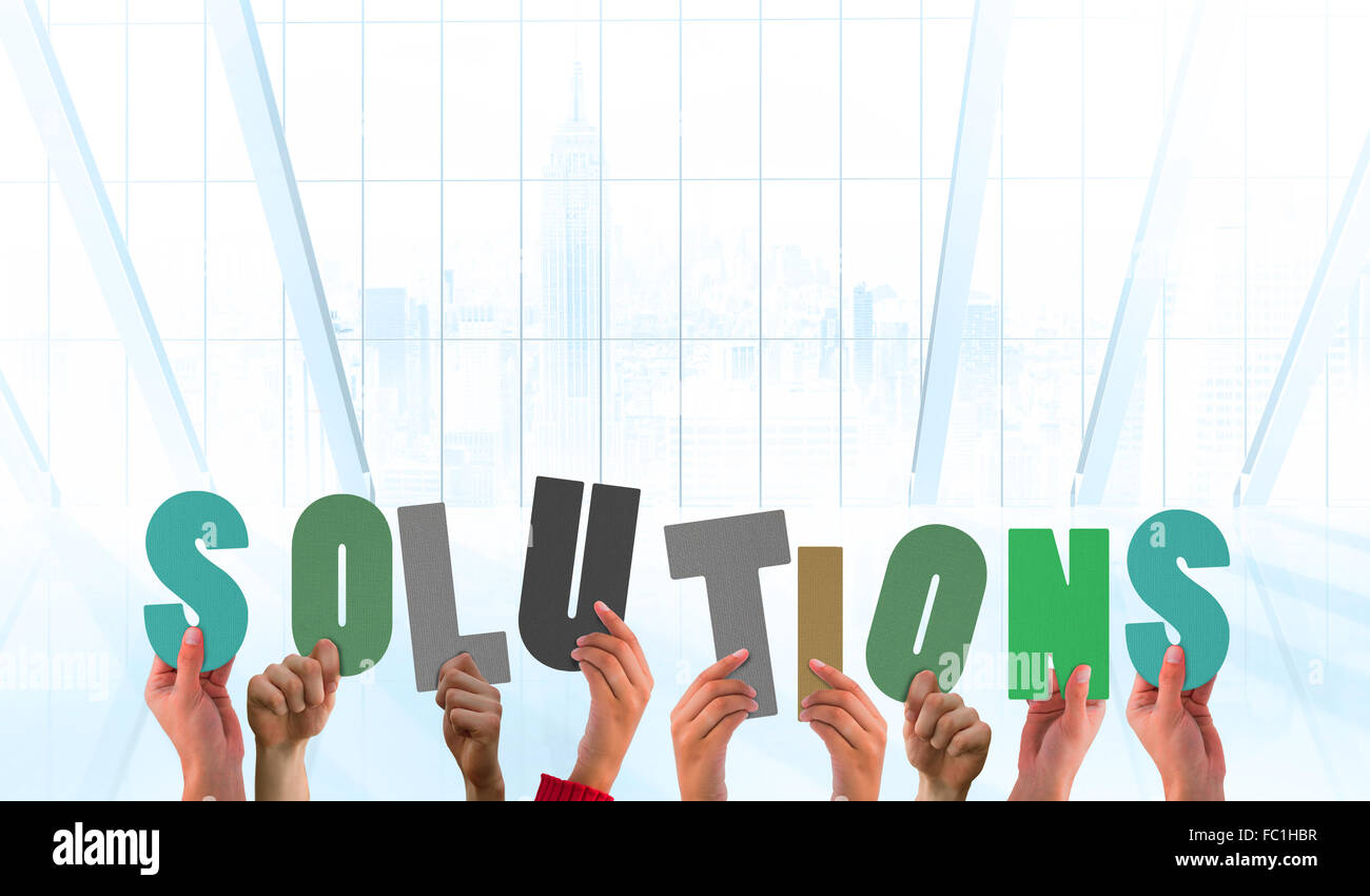 Composite image of hands holding up solutions Stock Photo - Alamy