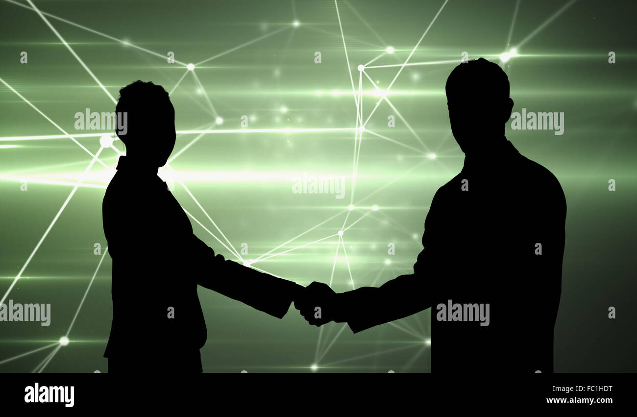 Composite image of smiling business people shaking hands while looking ...