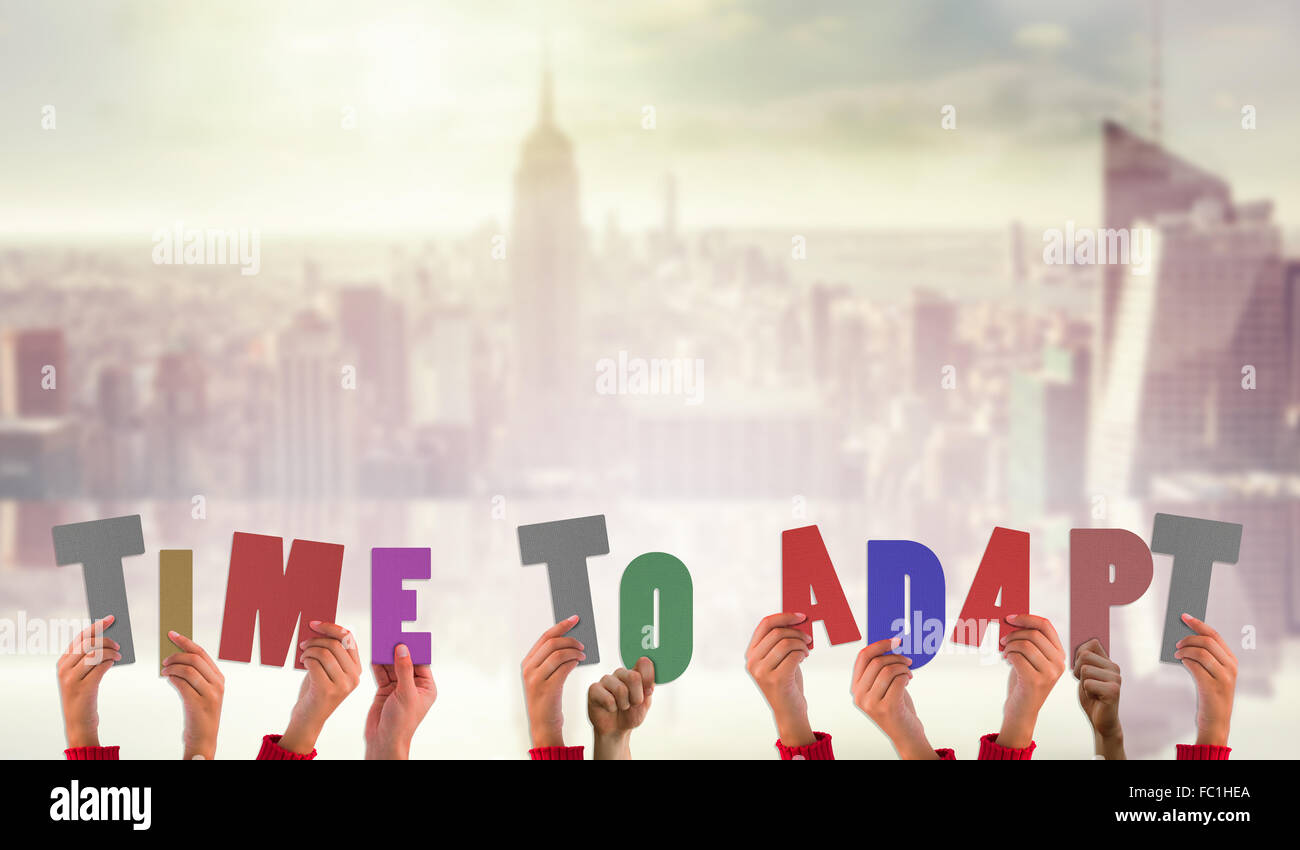 Composite image of hands holding up time to adapt Stock Photo - Alamy