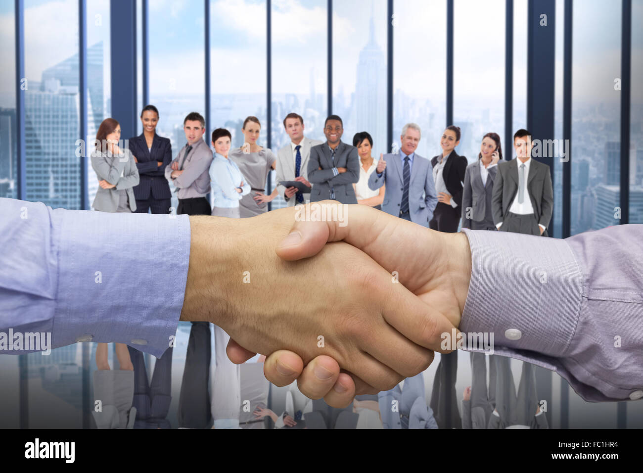 Composite image of hand shake in front of wires Stock Photo - Alamy