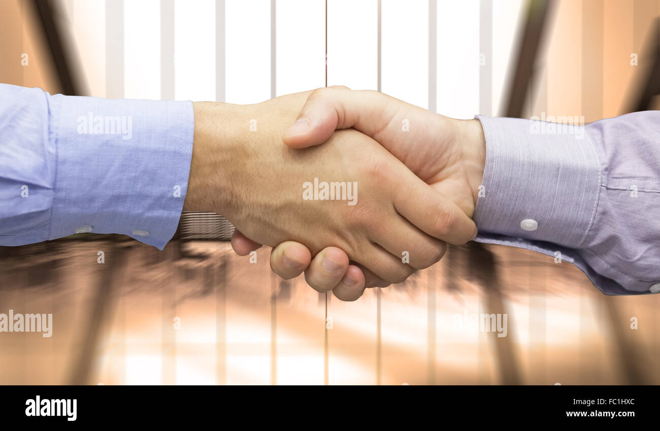 Composite image of hand shake in front of wires Stock Photo - Alamy
