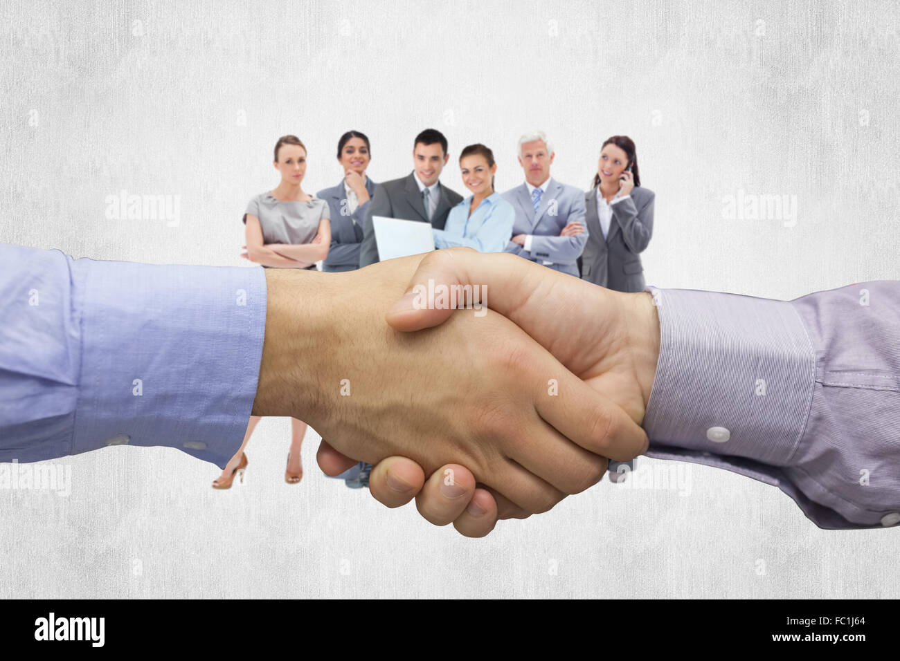 Composite image of hand shake in front of wires Stock Photo - Alamy