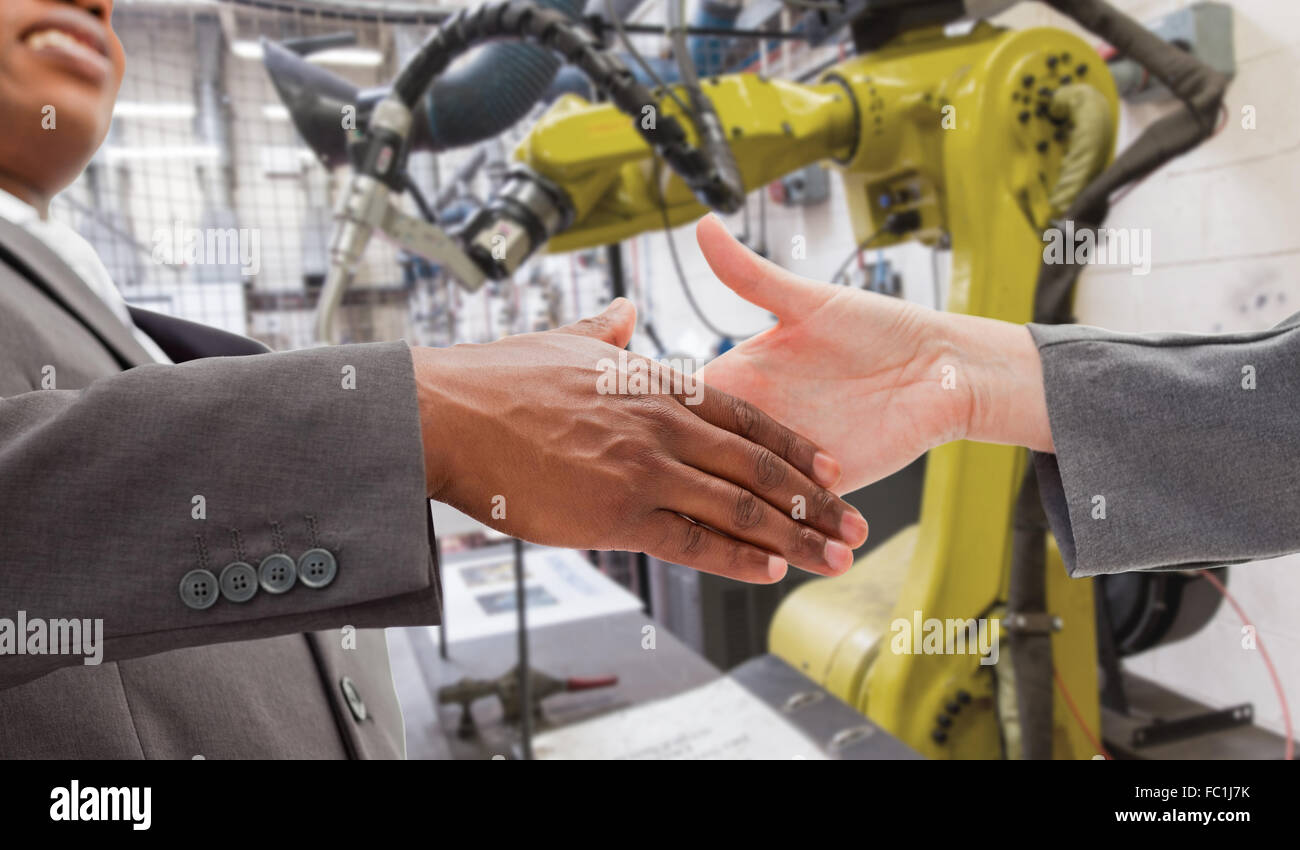 Composite image of businessman going shaking a hand Stock Photo - Alamy
