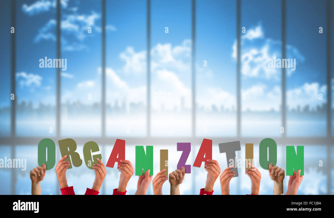 Composite image of hands holding up organization Stock Photo - Alamy