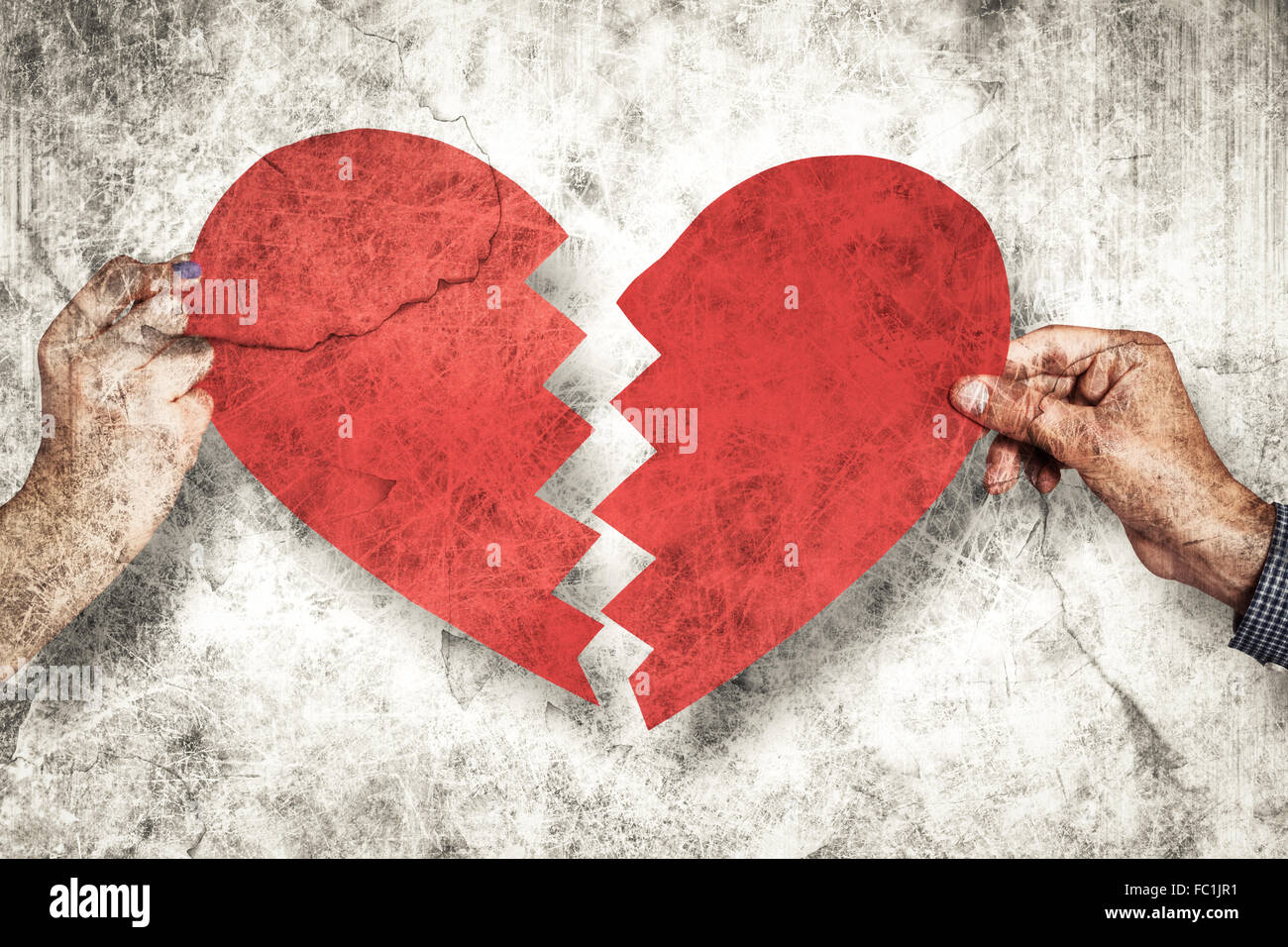 Composite image of two hands holding broken heart Stock Photo - Alamy