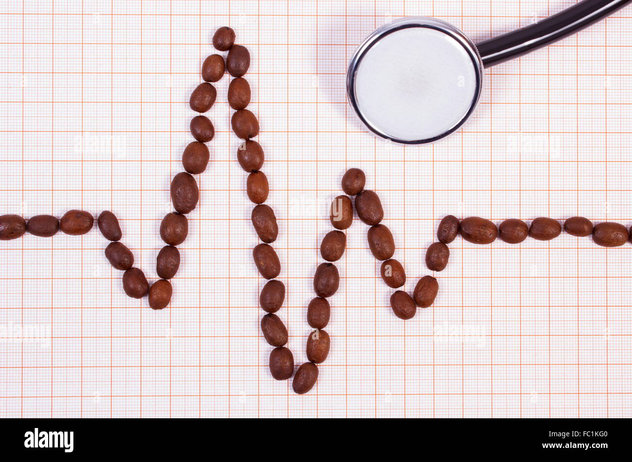 Electrocardiogram line of roasted coffee grains and medical stethoscope ...