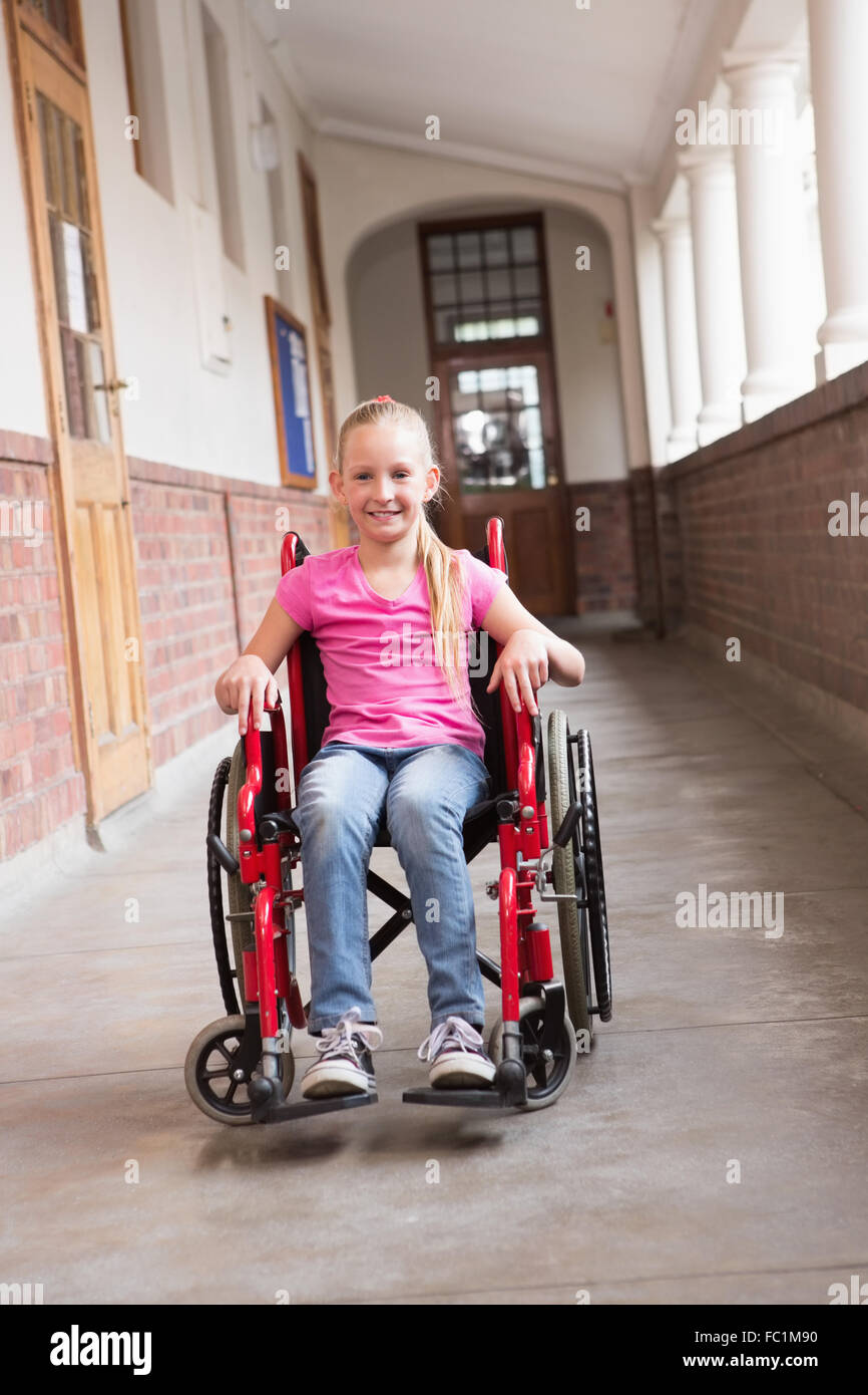 Cute disabled pupil smiling at camera in hall Stock Photo - Alamy