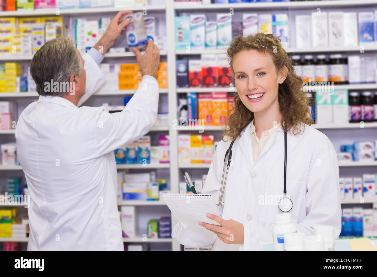 Pharmacists searching medicines with prescription Stock Photo - Alamy