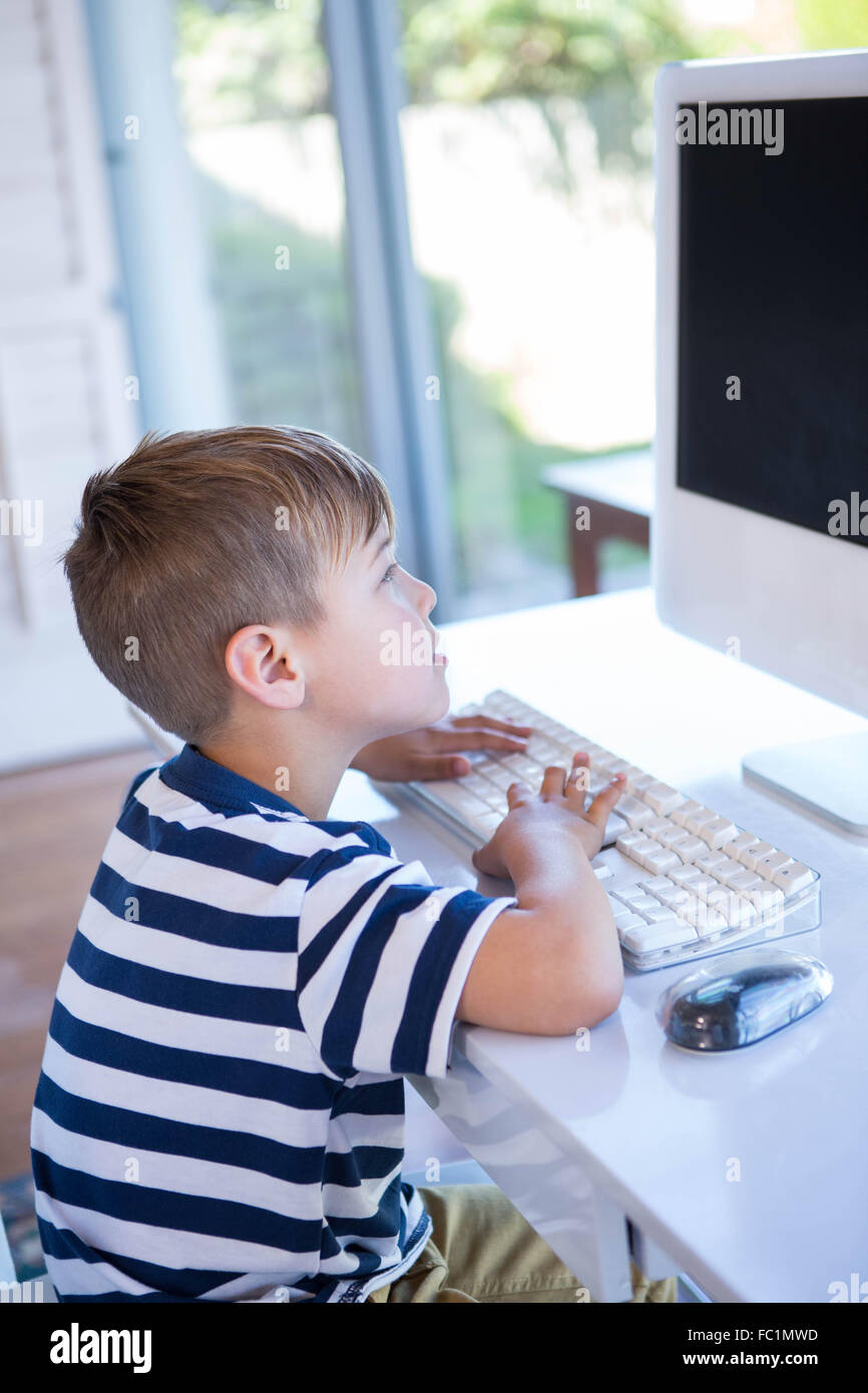 Little boy using computer in the living room Stock Photo - Alamy
