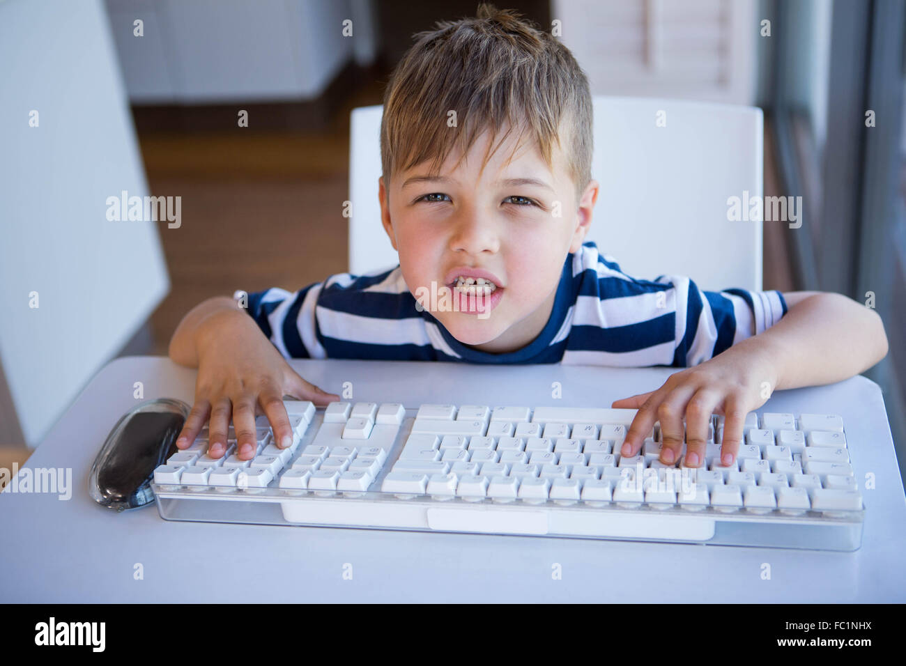 Little boy using computer in the living room Stock Photo - Alamy