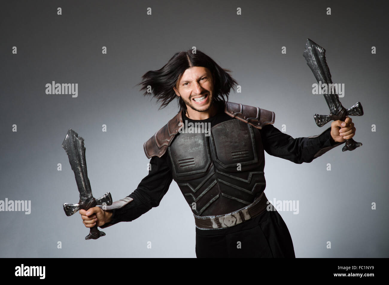 Angry knight with sword against dark background Stock Photo - Alamy