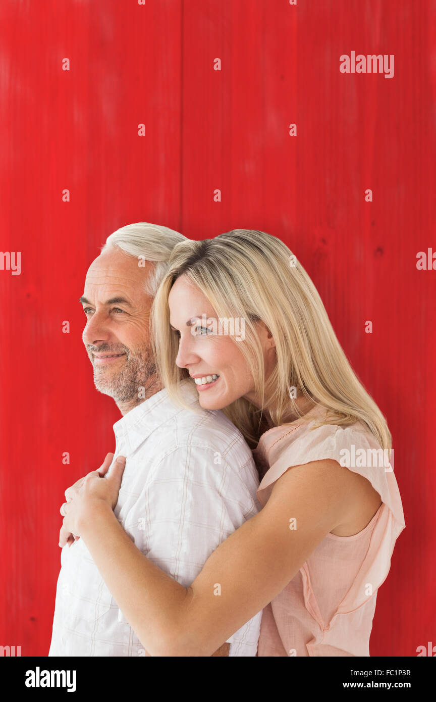 Composite image of affectionate couple standing and hugging Stock Photo ...