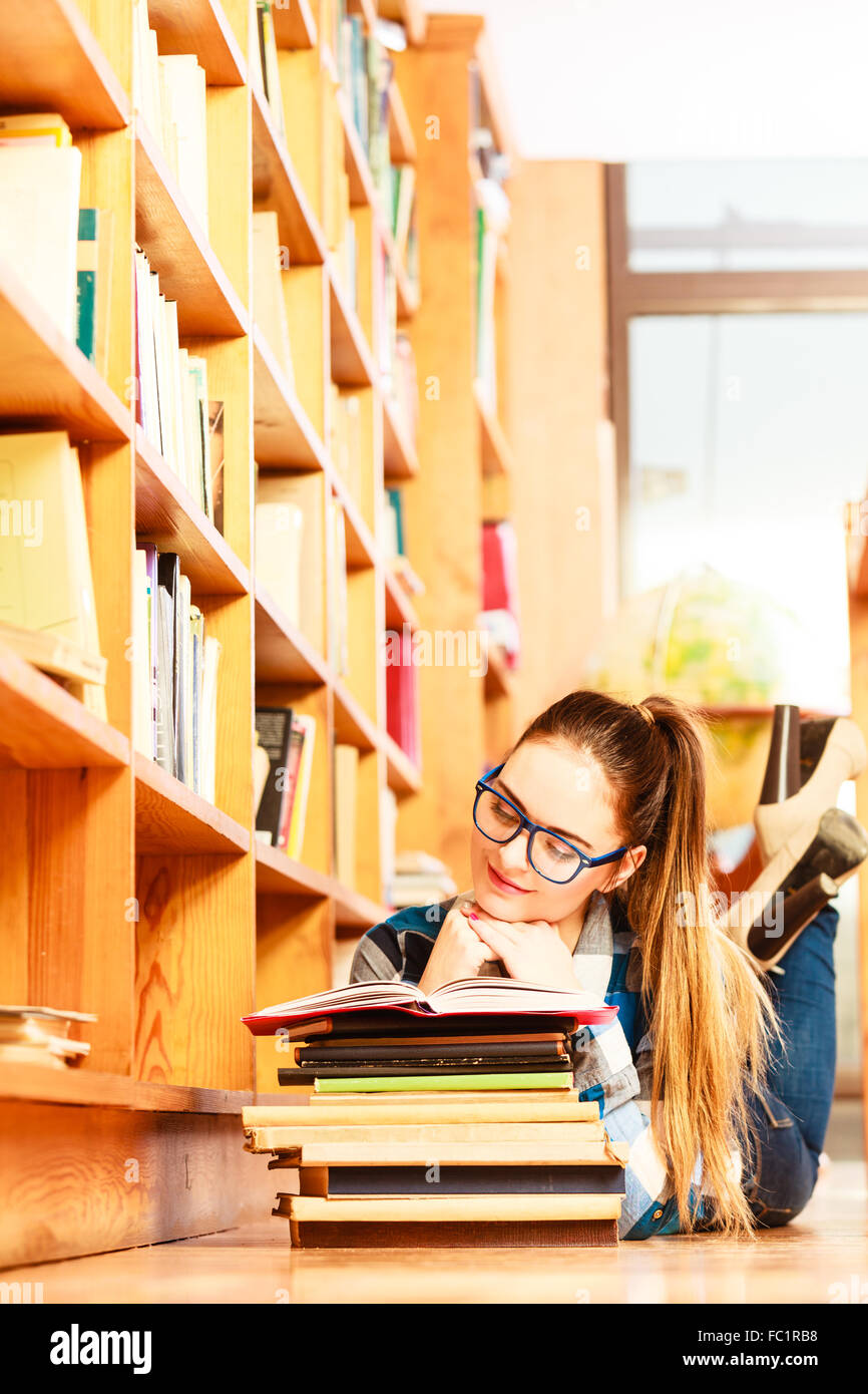 Woman student in college library Stock Photo - Alamy