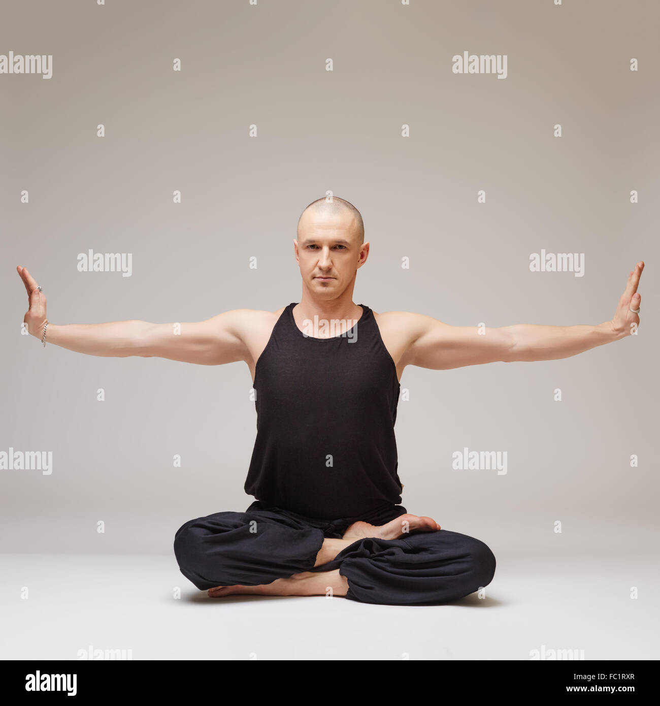 Attractive yoga guru posing while exercising Stock Photo - Alamy