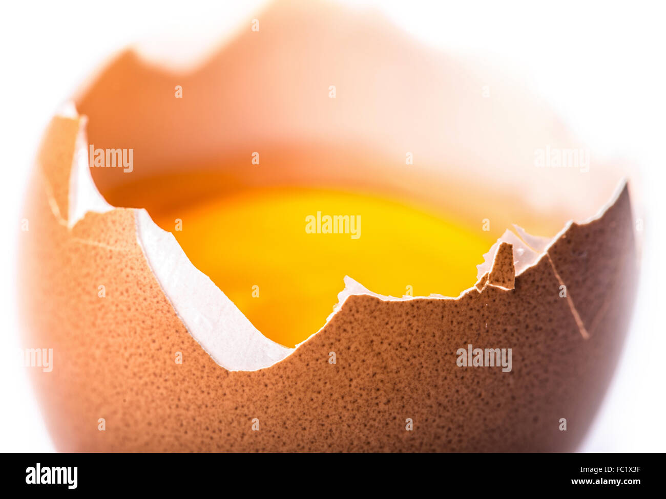 broken egg on white background Stock Photo - Alamy