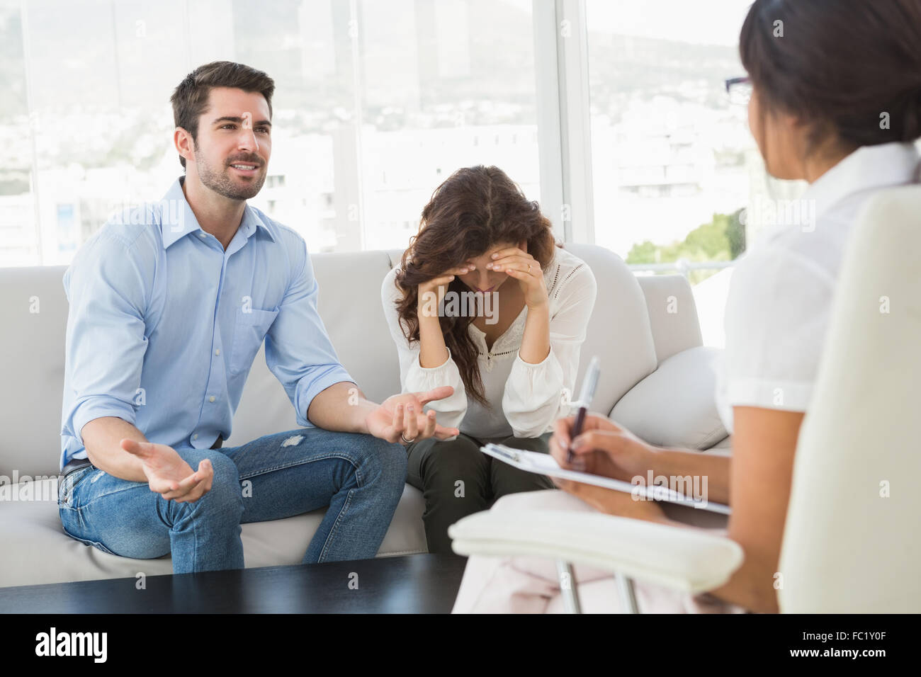 Couple fighting together in front of their therapist Stock Photo - Alamy