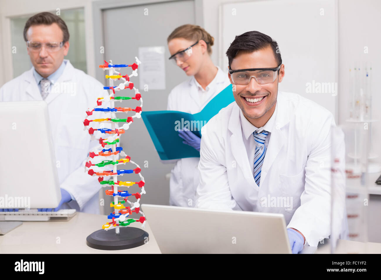 Male scientist using laptop dna hi-res stock photography and images - Alamy