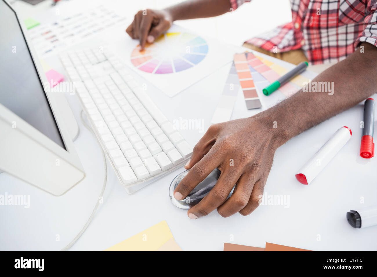 Businessman pointing colour wheel and using mouse Stock Photo - Alamy