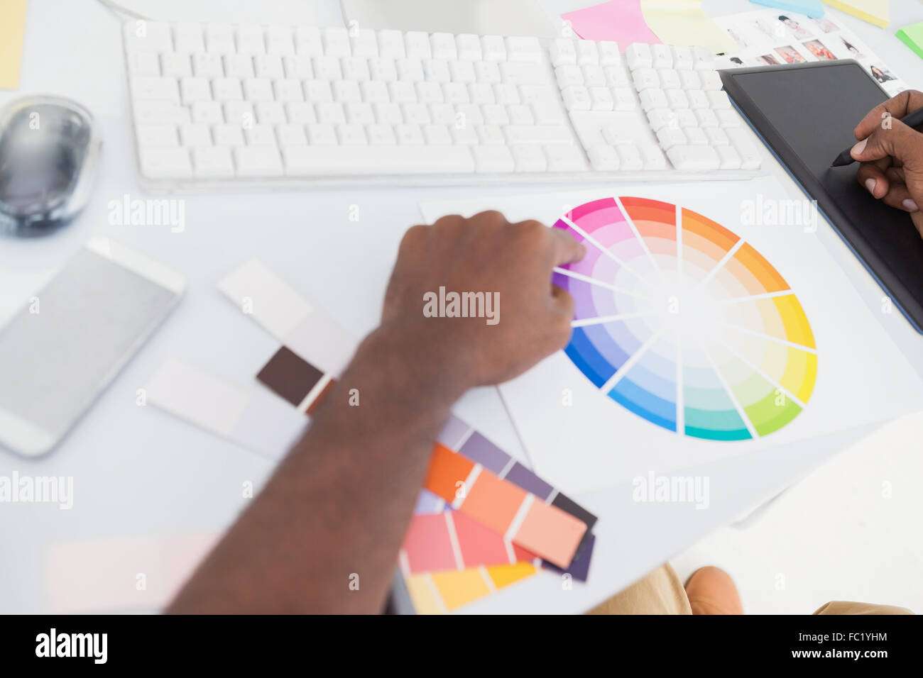 Designer using graphics tablet and colour wheel Stock Photo - Alamy