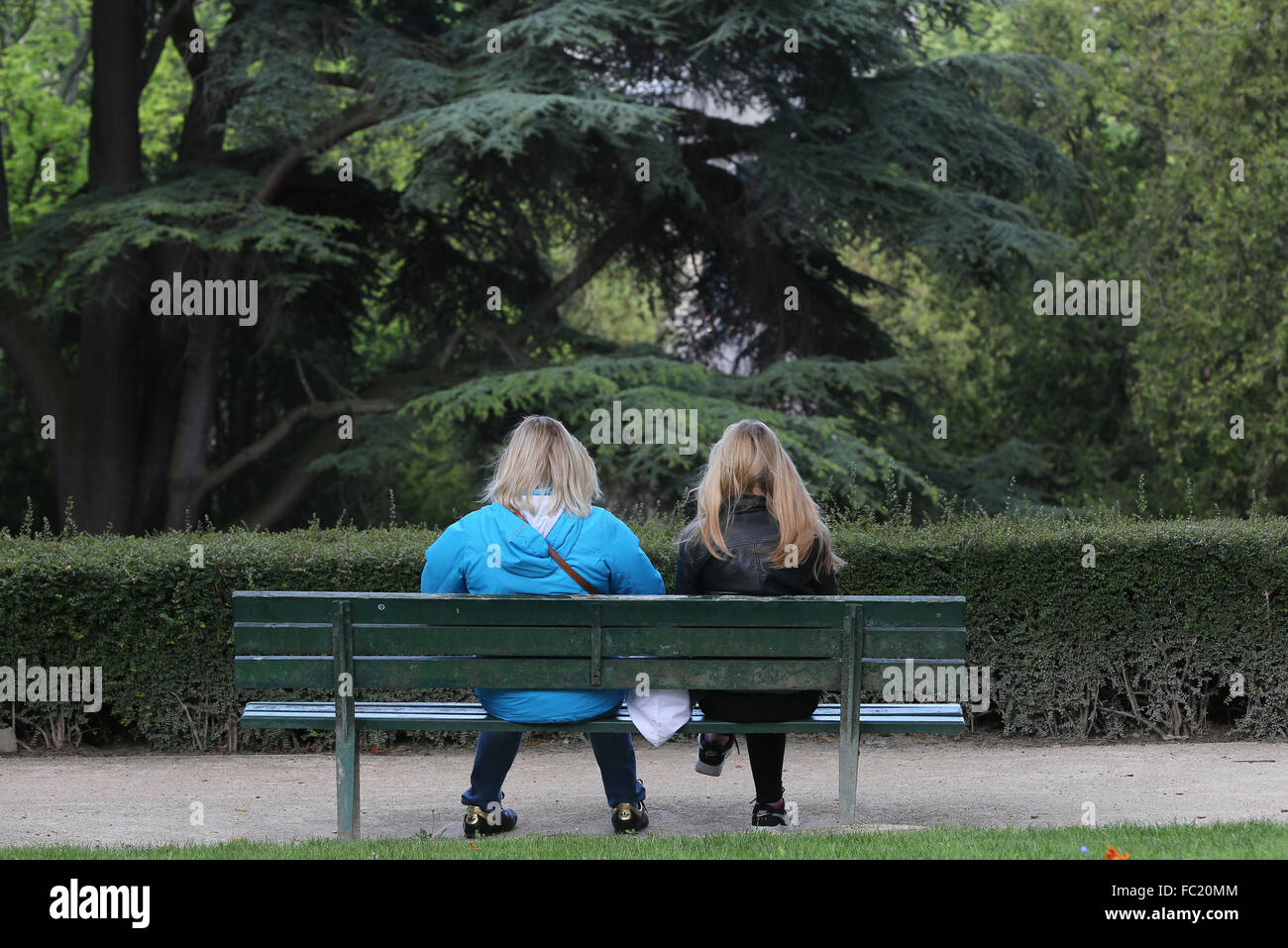 Two girls on a bench Stock Photo - Alamy