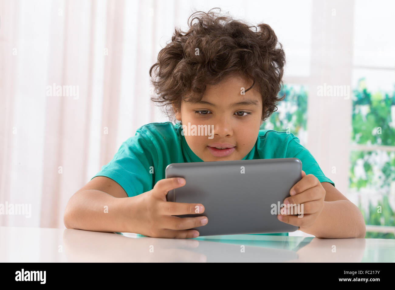 CHILD WITH TABLET Stock Photo - Alamy