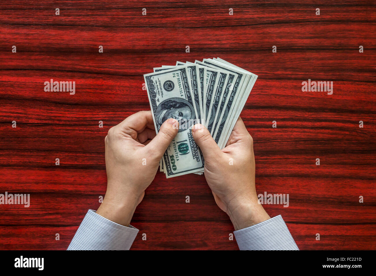 Hands counting money on a desk Stock Photo - Alamy