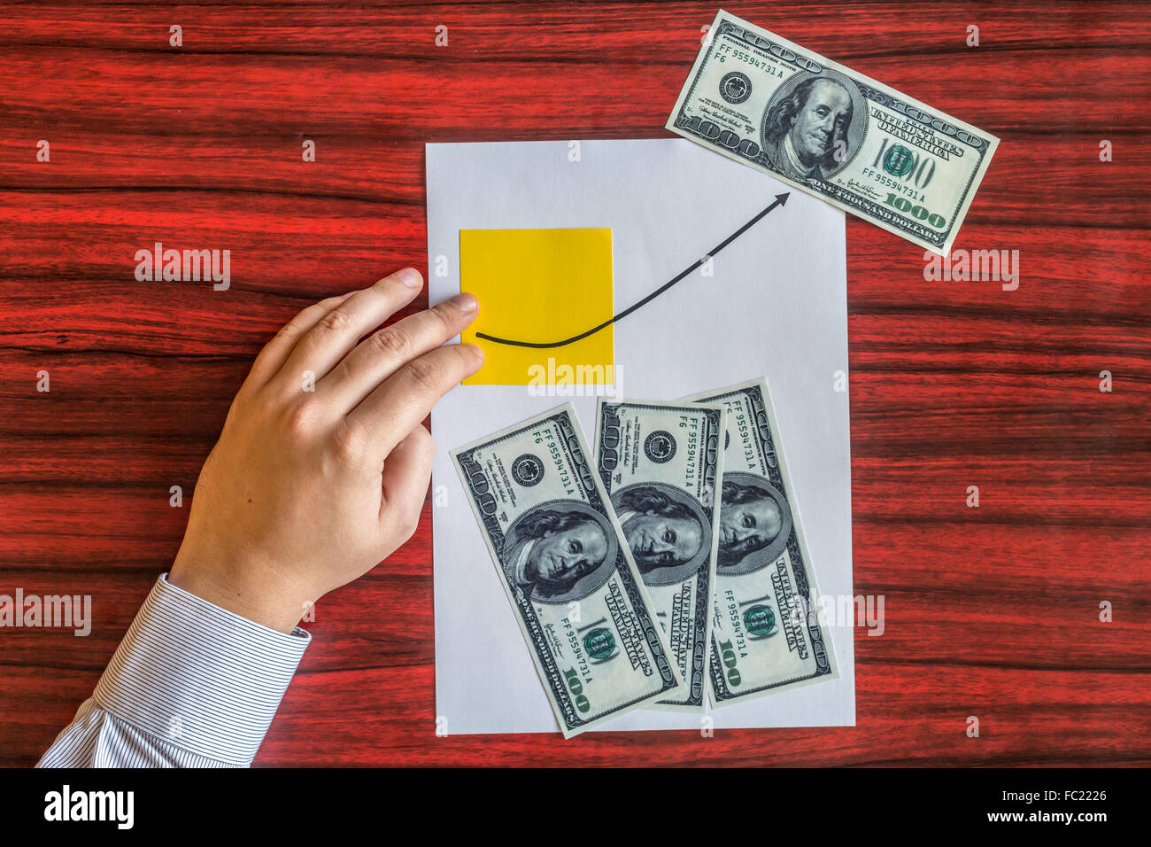 Left hand moving yellow note to match the curve on a white paper page ...