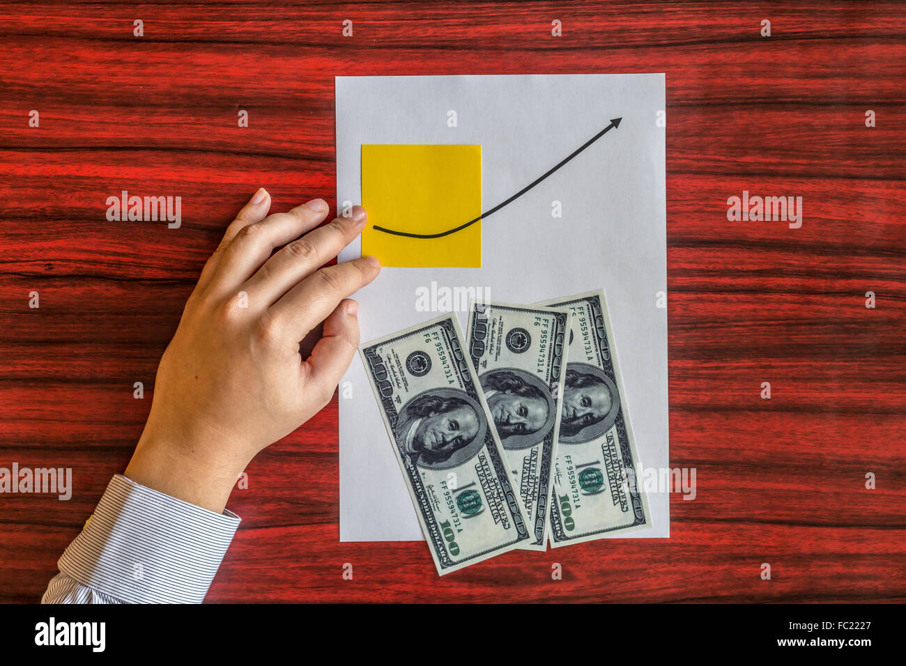 Left hand moving yellow note to match the curve on a white paper page ...
