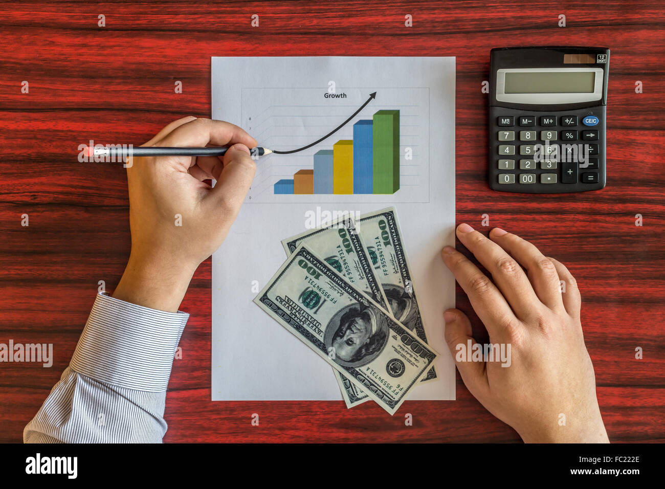 Left handed person analyzing charts Stock Photo - Alamy