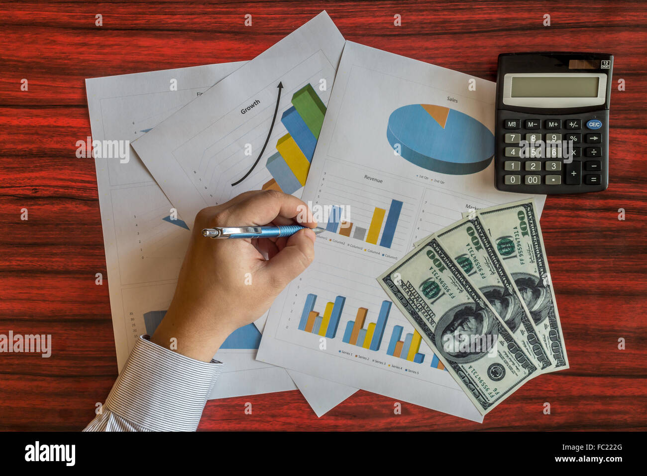 Left handed person analyzing charts Stock Photo - Alamy
