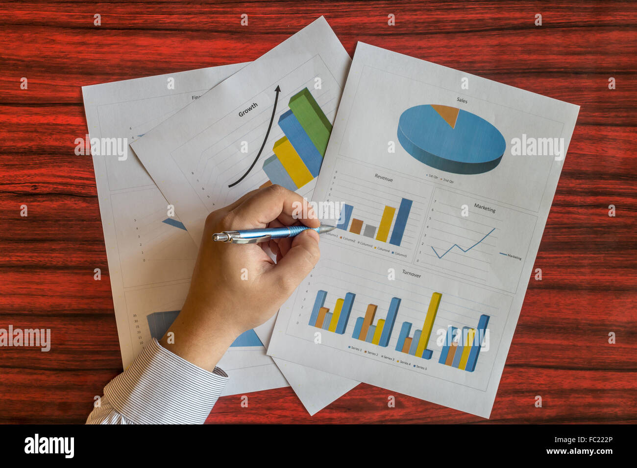 Left handed person analyzing charts Stock Photo - Alamy