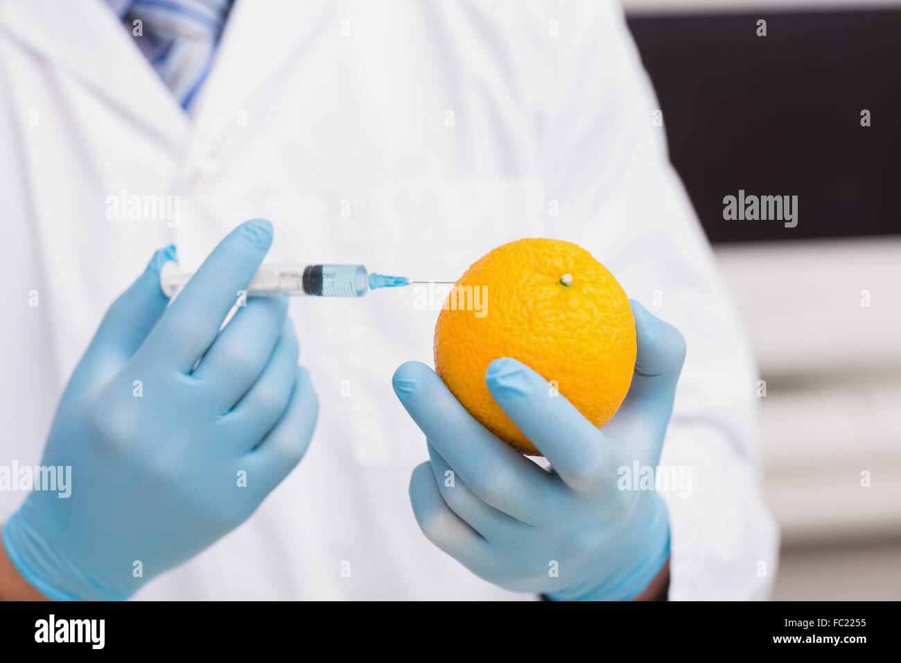 Syringe injecting orange fruit hi-res stock photography and images - Alamy