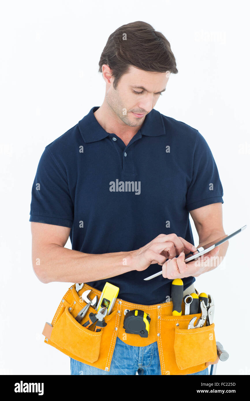 Handyman using digital table over white background Stock Photo - Alamy