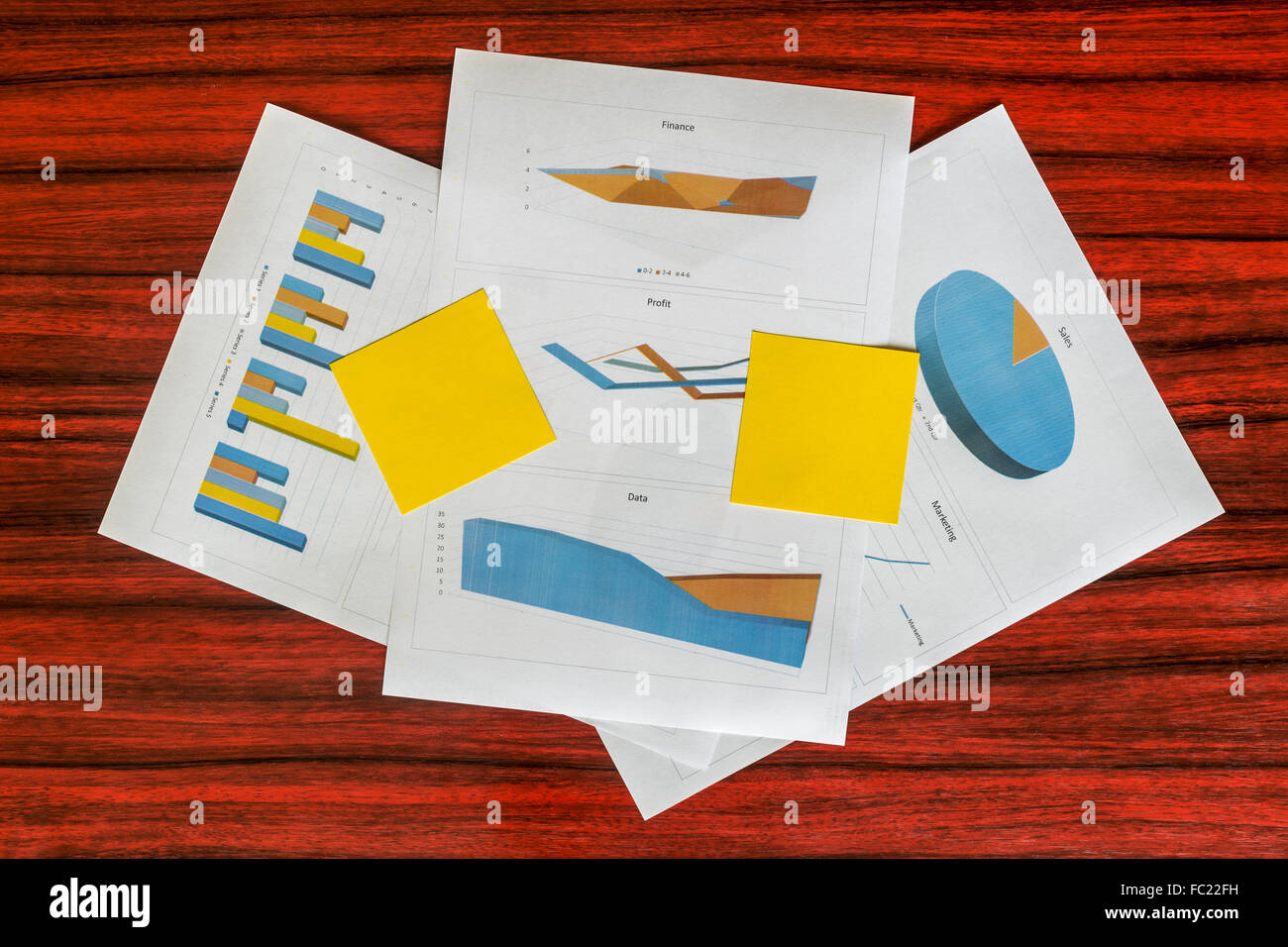 Bunch of printed charts and graphs with yellow sticky notes Stock Photo ...