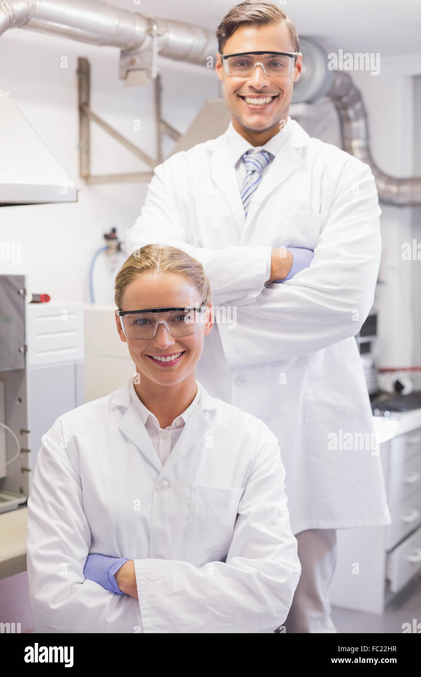 Smiling scientists looking at camera arms crossed Stock Photo - Alamy
