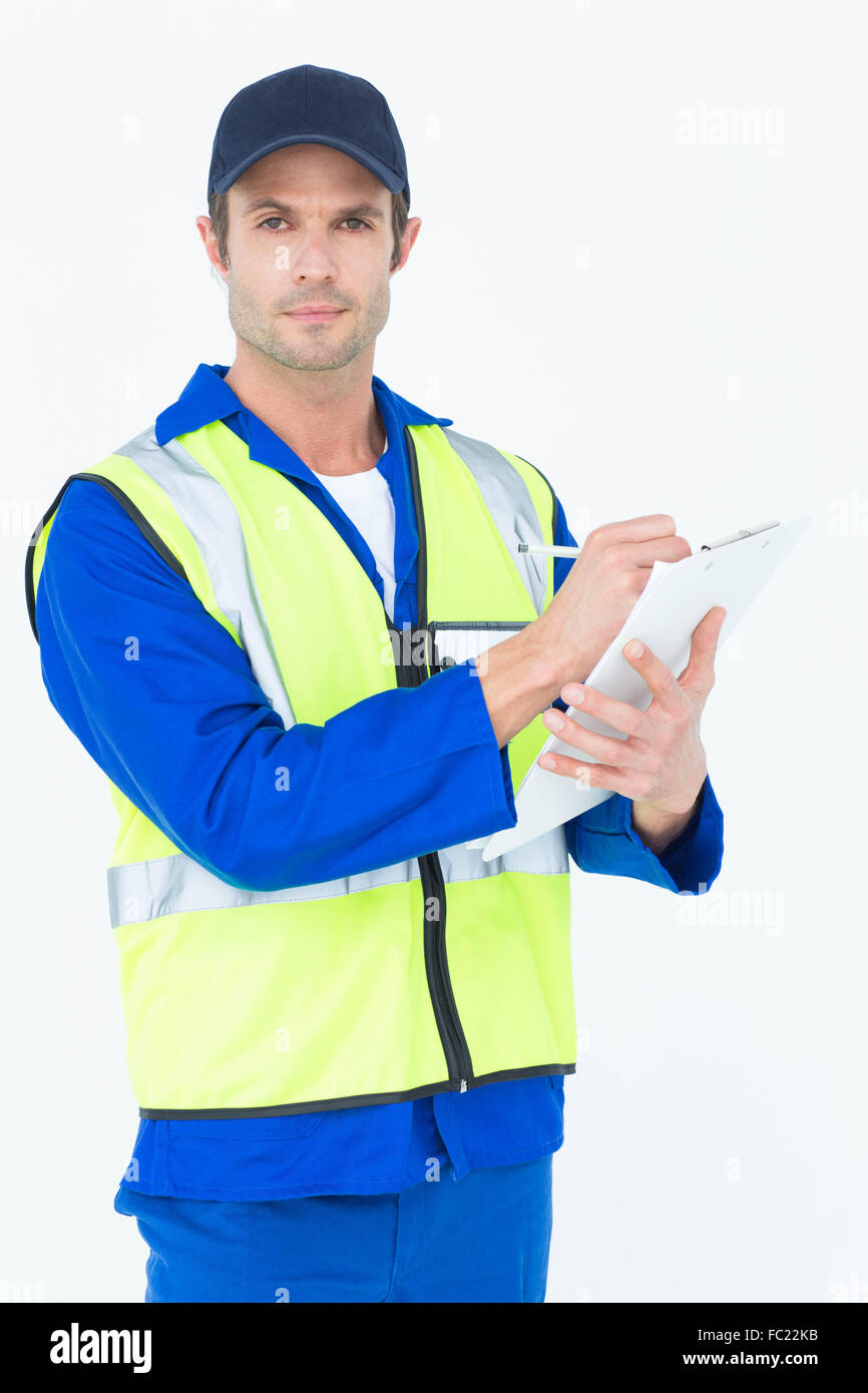 Confident supervisor writing notes on clipboard Stock Photo - Alamy
