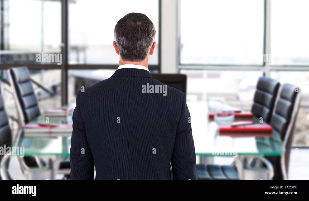 Composite image of rear view of an elegant businessman Stock Photo - Alamy