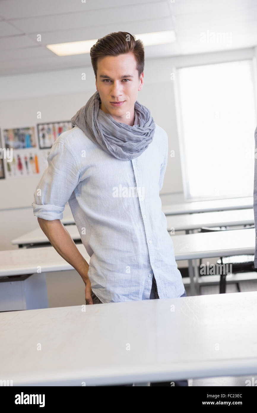 Smiling student standing and posing in classroom Stock Photo - Alamy