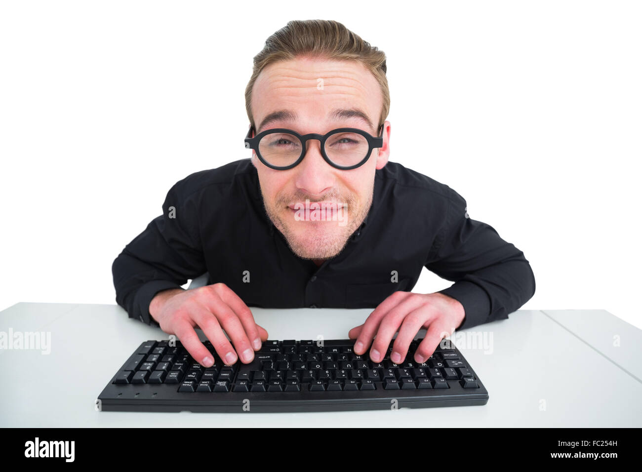 Smiling businessman typing on keyboard at desk Stock Photo - Alamy