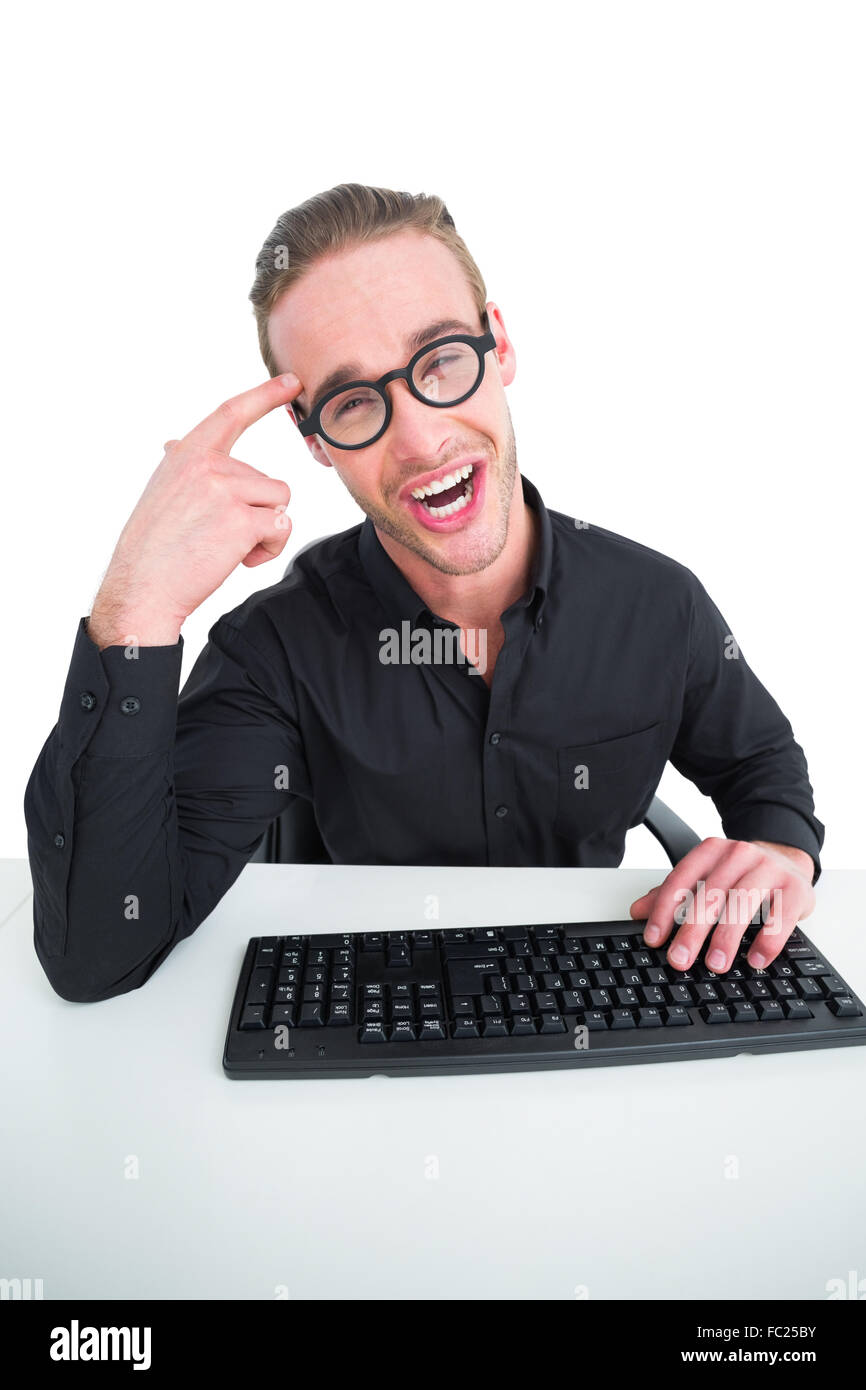 Businessman making a face and typing on keyboard Stock Photo - Alamy