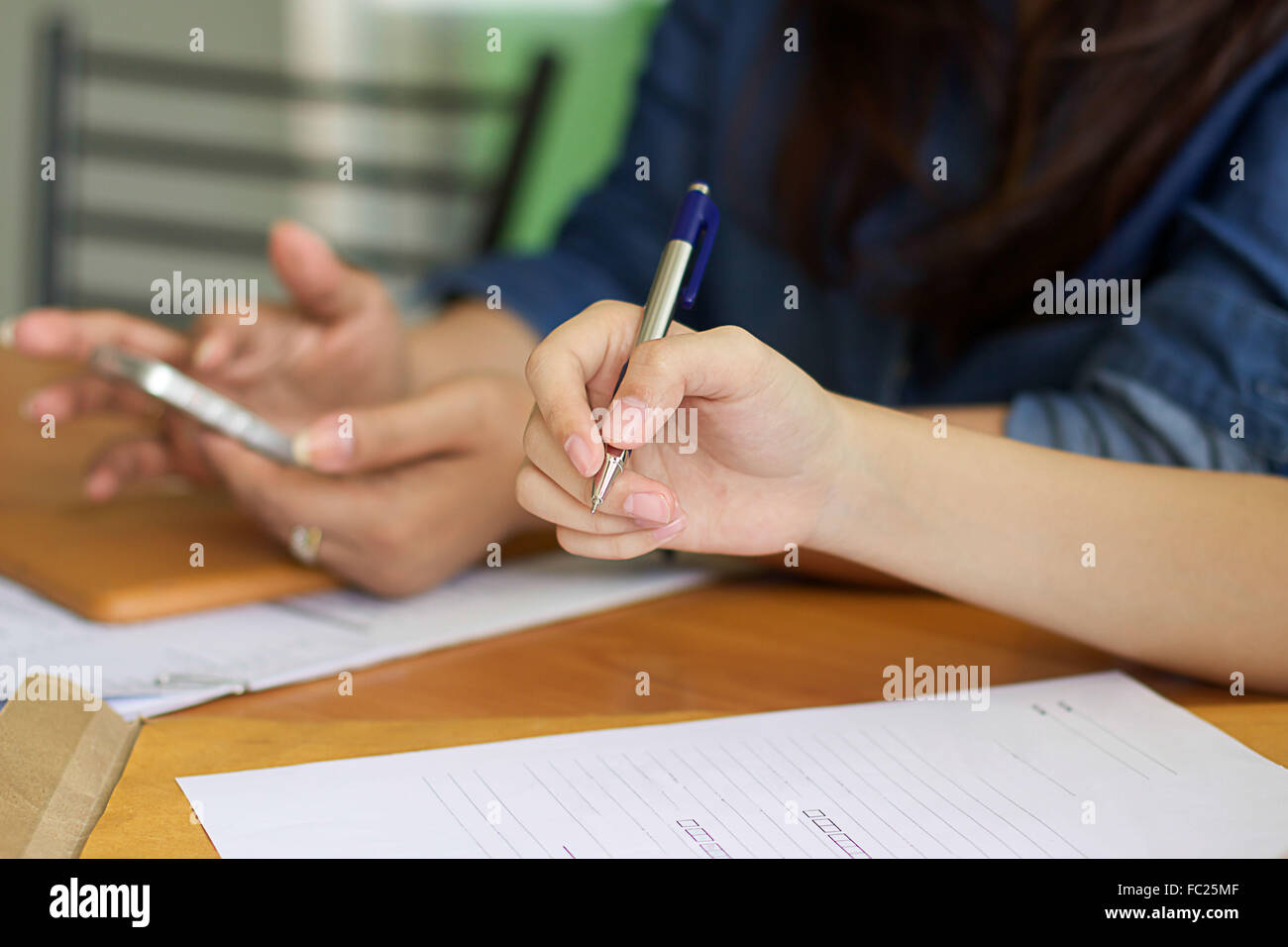 Business Women filling form for agreement Stock Photo - Alamy