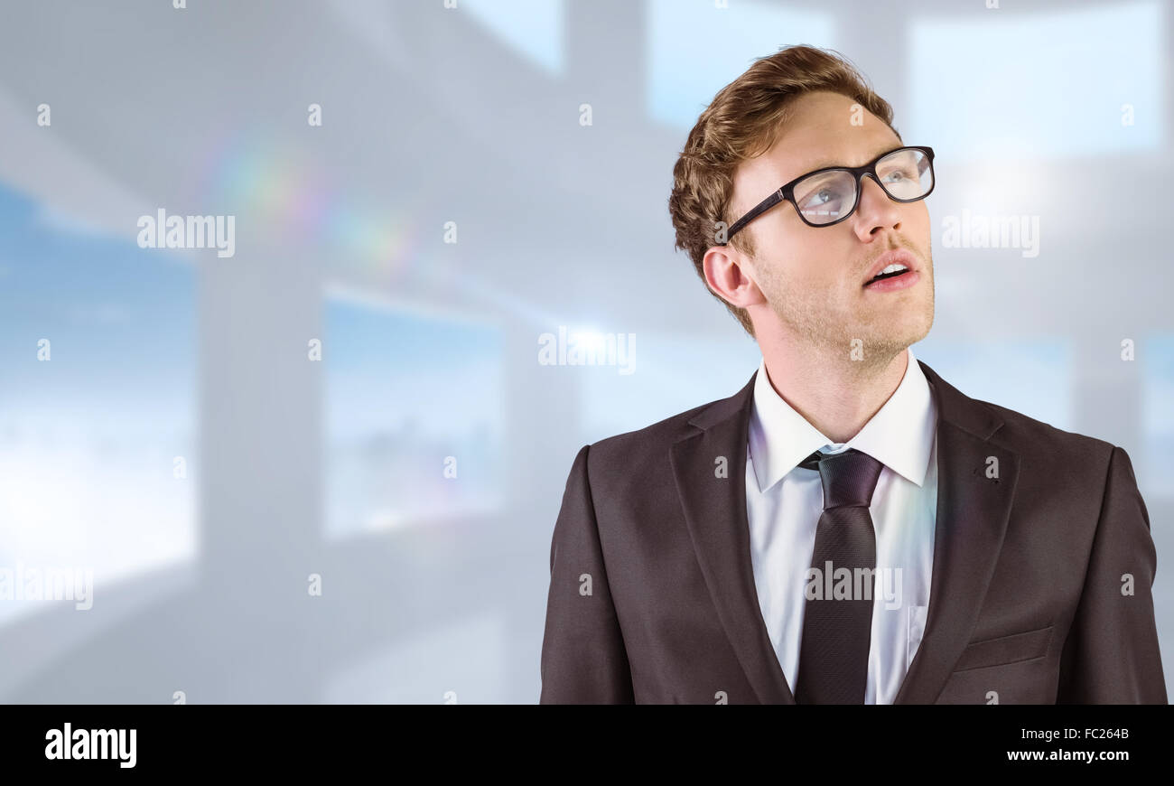 Composite image of young businessman thinking and looking up Stock ...
